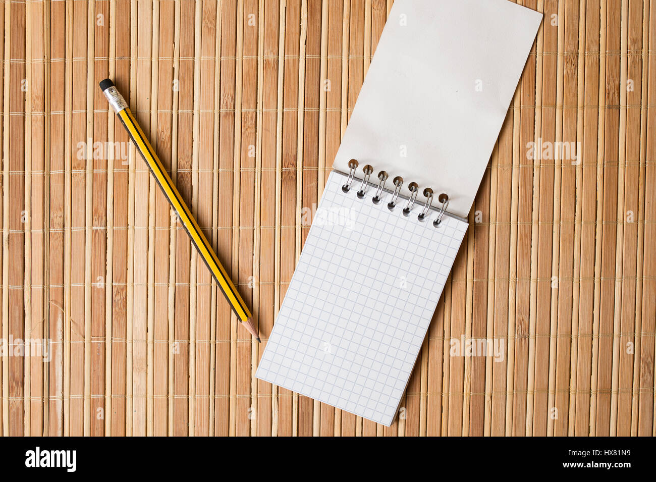 Notepad and pencil on a bamboo table Stock Photo - Alamy