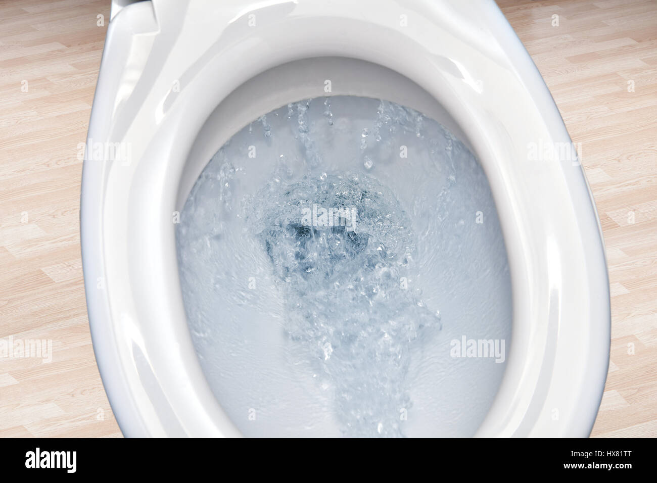 Toilet bowl flushing water in bathroom close up Stock Photo - Alamy