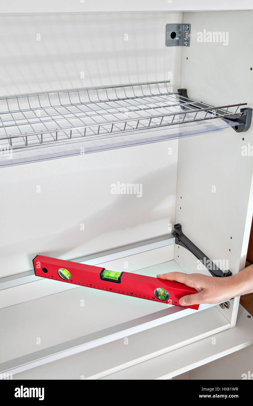 Installation of kitchen furniture, assembling of shelving plate rack ...