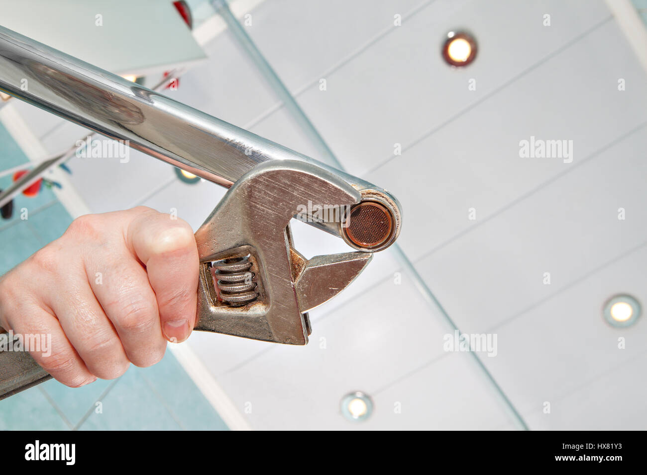 Remove old aerator from tap with an adjustable spanner, closeup Stock ...