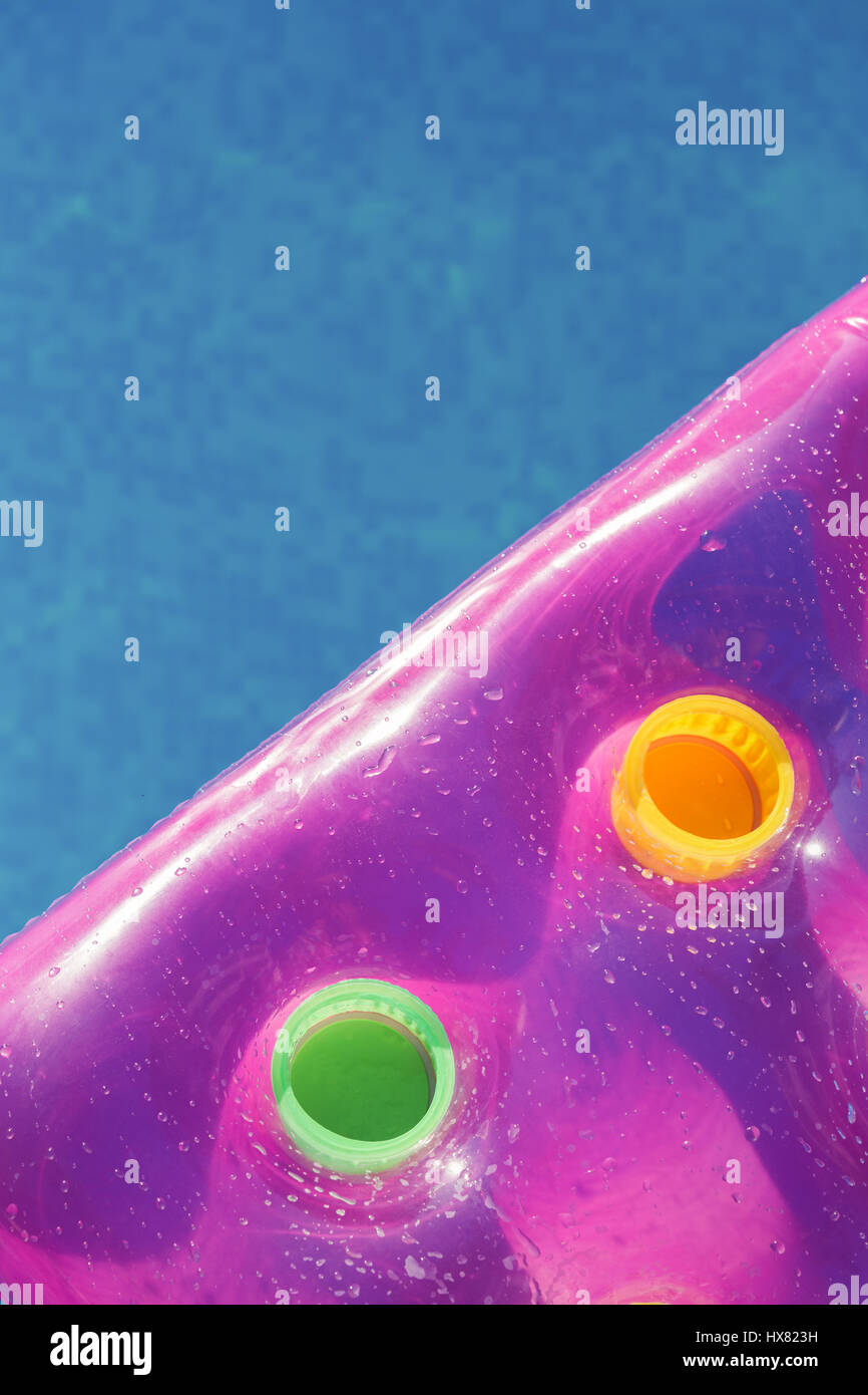 Pink air mattress on a swimming pool - holiday tropical background ...