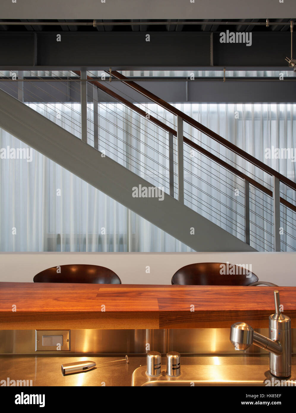 Detail of bar stools and stairs leading to the third floor. Panel House ...