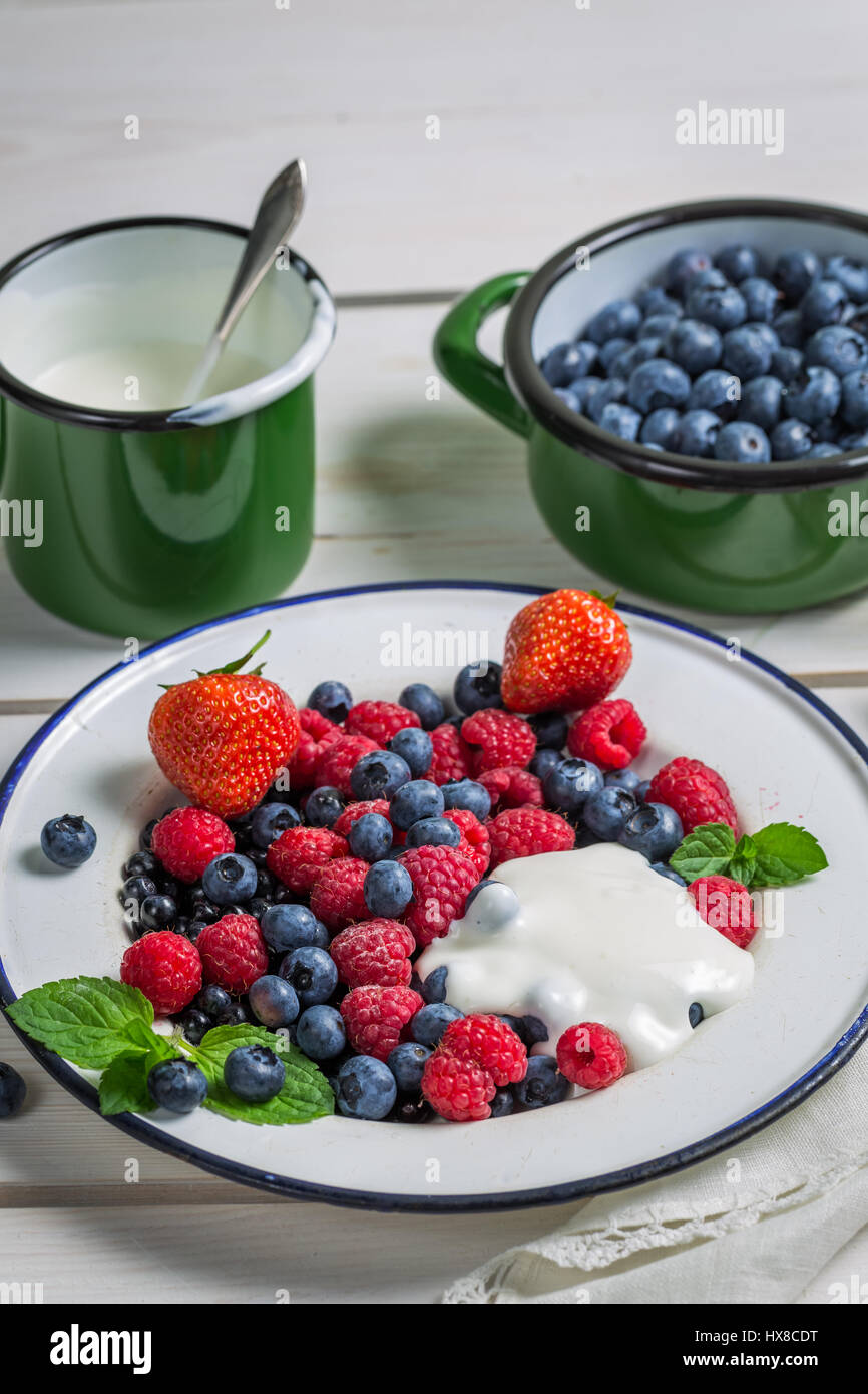 Fresh berry, strawberry and raspberry on wooden table Stock Photo - Alamy