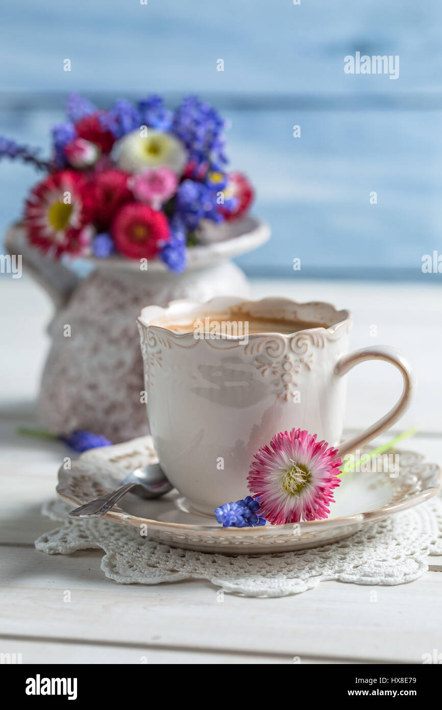 Cup of hot coffee and spring flowers Stock Photo - Alamy