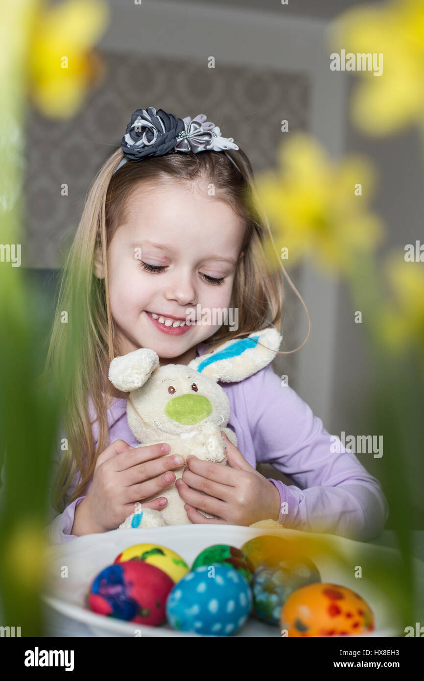 Smiling cute child with easter eggs and plush bunny. Easter. Easter ...