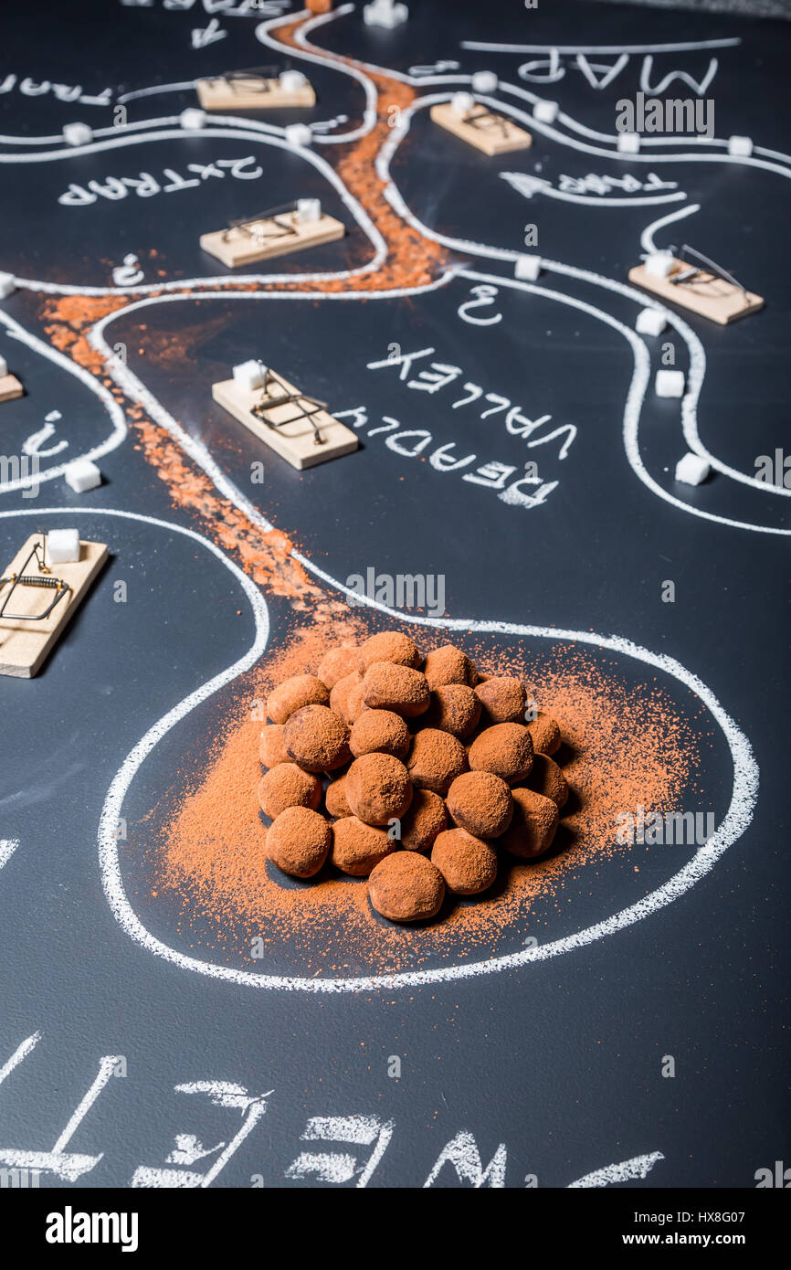 Map and sweet treasure on black blackboard Stock Photo - Alamy