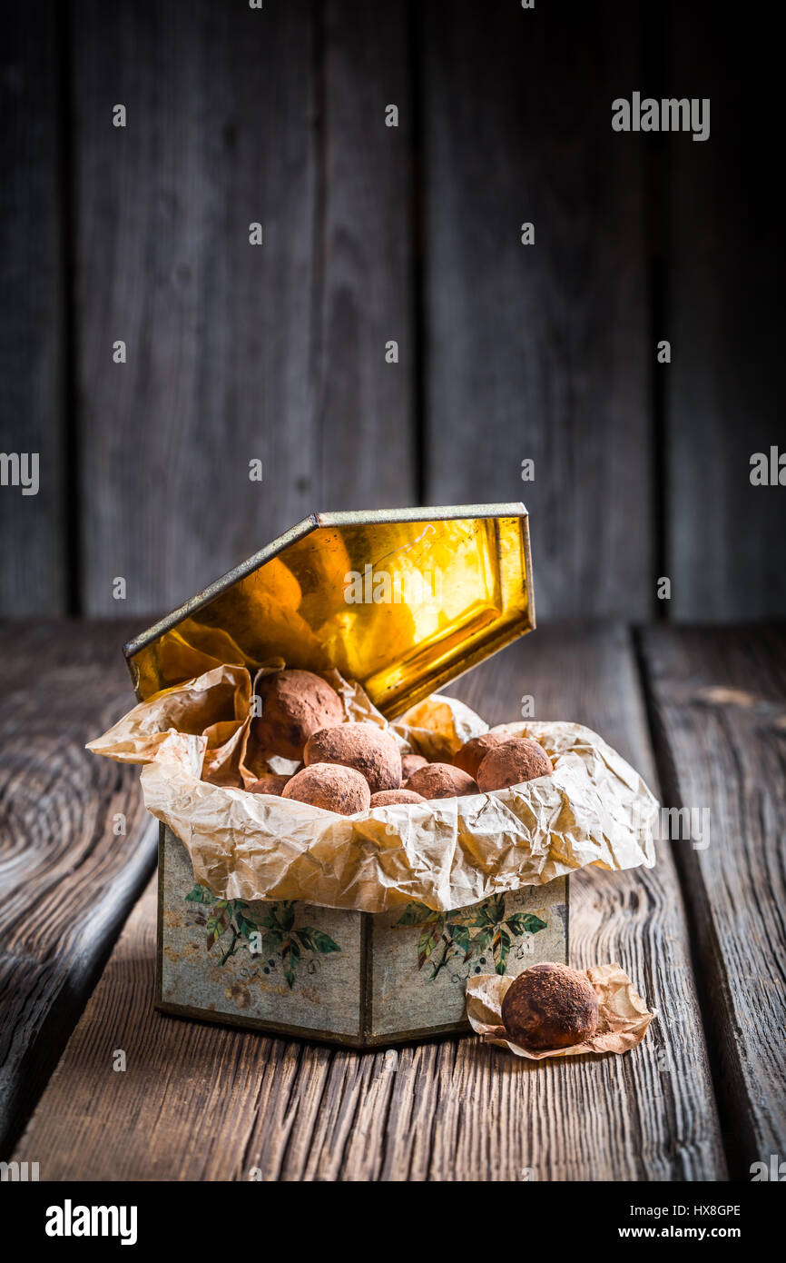 Closeup of chocolate balls in golden box Stock Photo - Alamy