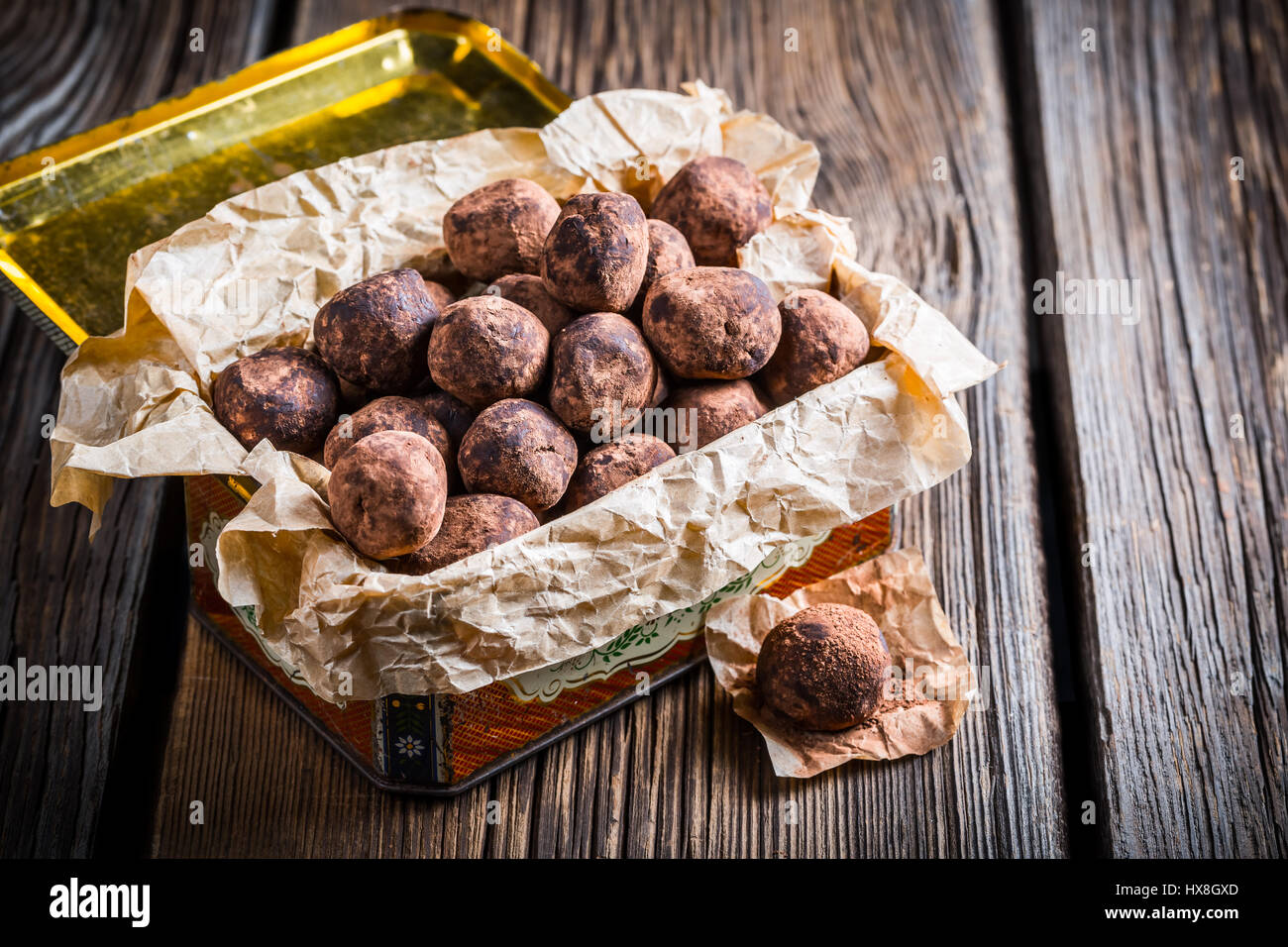 Small pile of chocolate balls in the box Stock Photo - Alamy