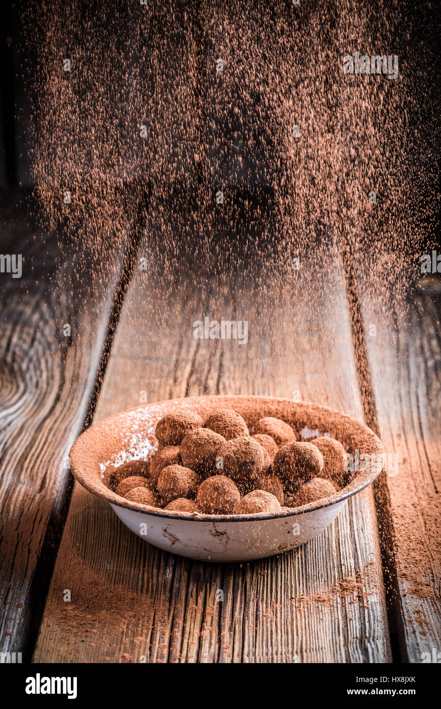 Sweet chocolate balls in white bowl and cocoa powder Stock Photo - Alamy