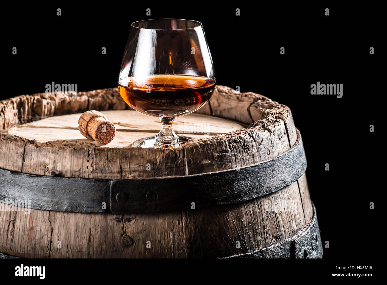 Glass of cognac on old wooden barrel Stock Photo - Alamy
