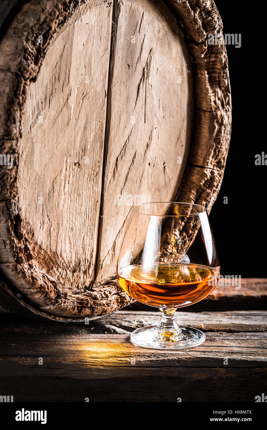 Wooden oak barrel and a glass of cognac Stock Photo - Alamy