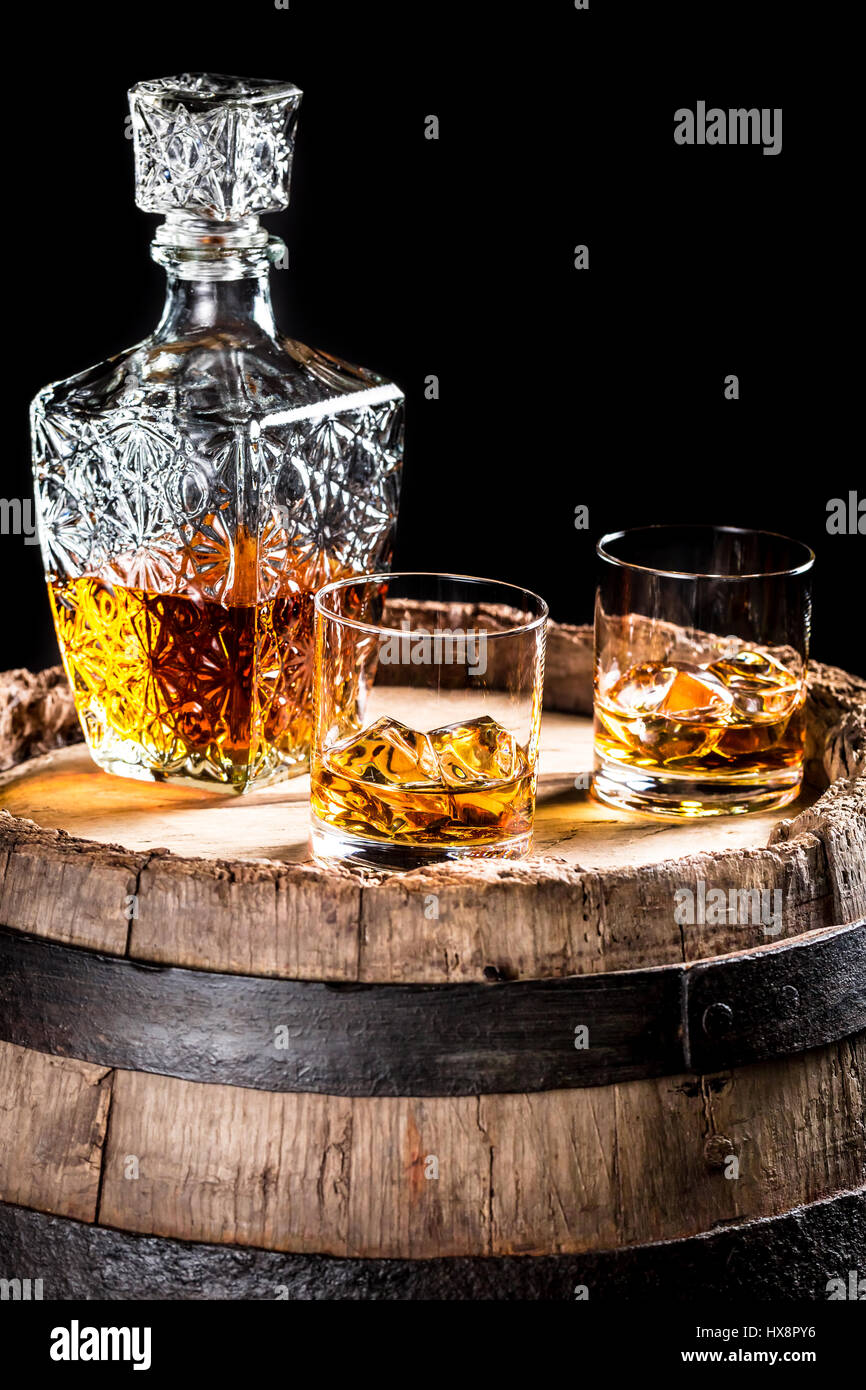 Two glassed of aged brandy or whiskey on the rocks Stock Photo - Alamy