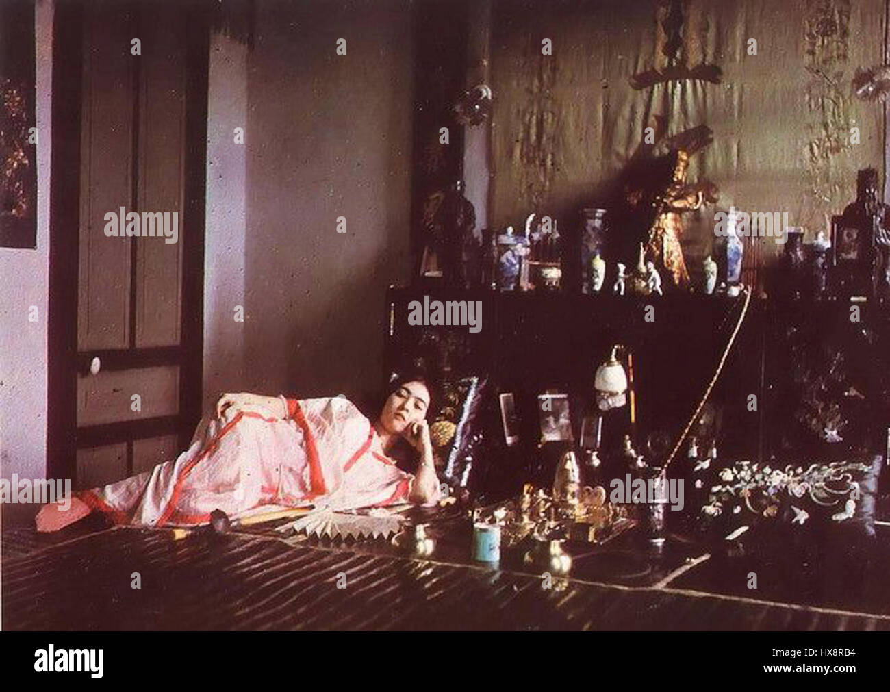 This image portrays a woman smoking opium, reflecting the social and ...