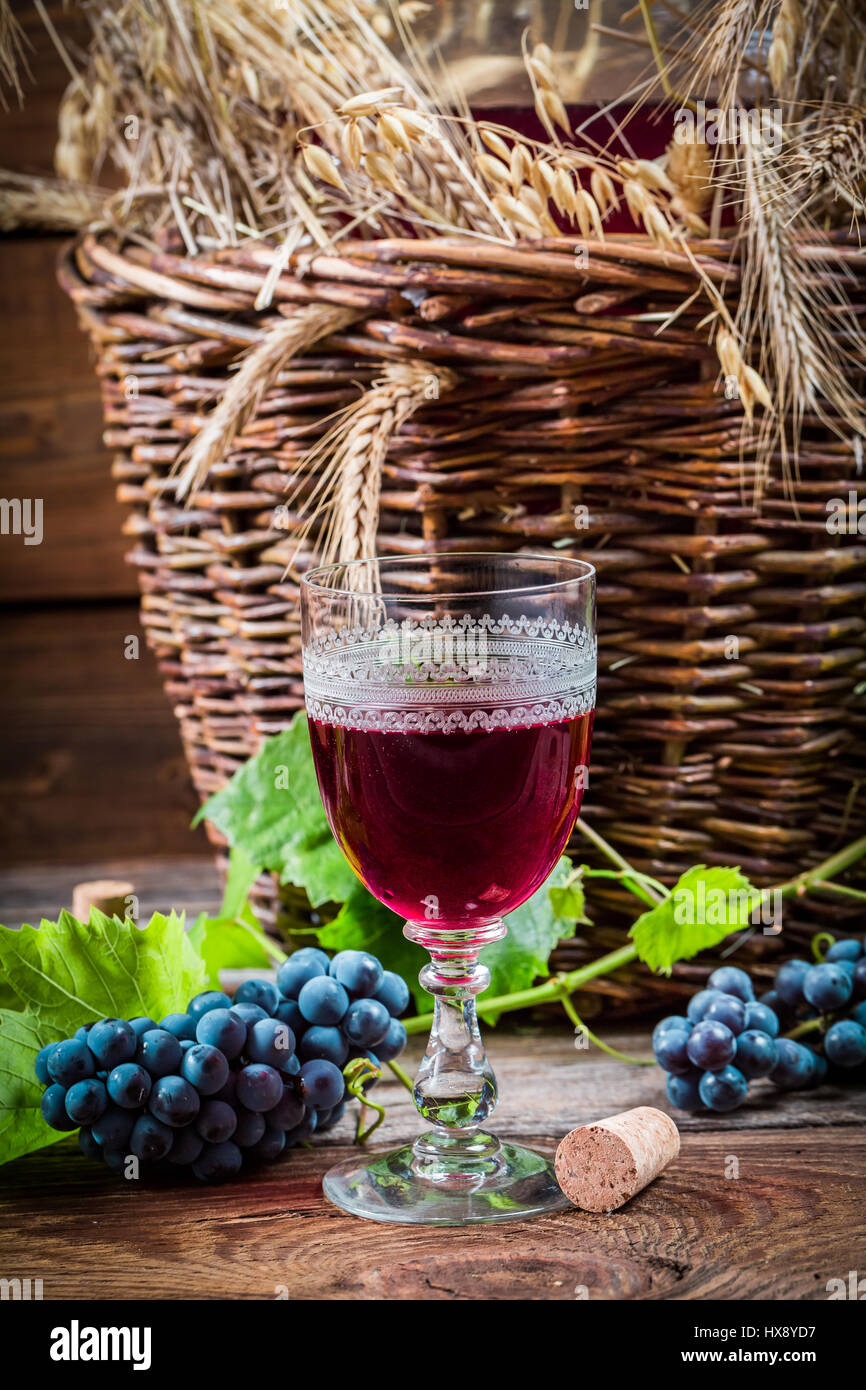 Taste of red wine straight from the demijohn Stock Photo - Alamy