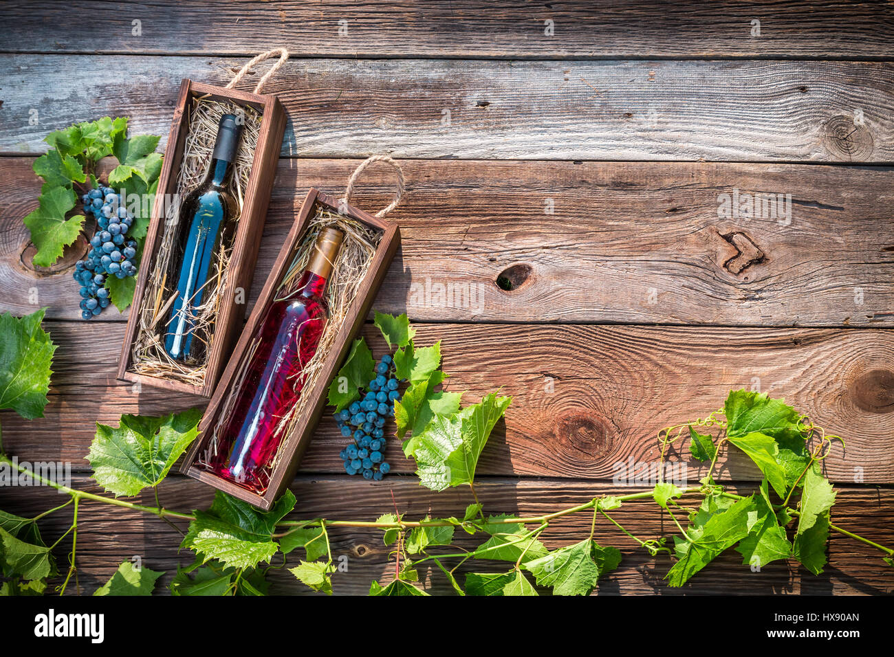 Different types of wine in a wooden box and grapes Stock Photo - Alamy