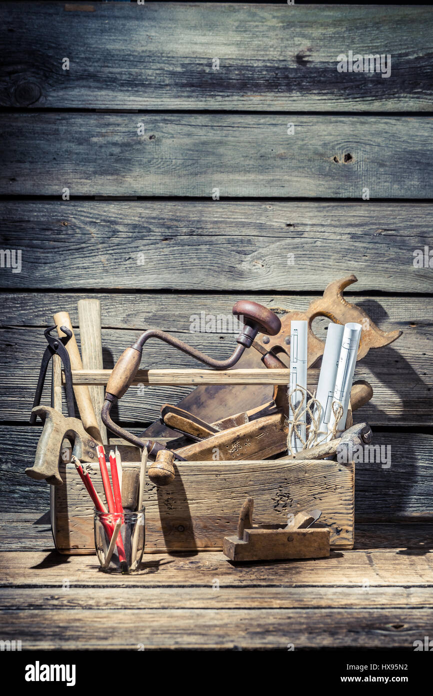 Vintage carpenter tools in wooden toolbox on old wooden table Stock ...