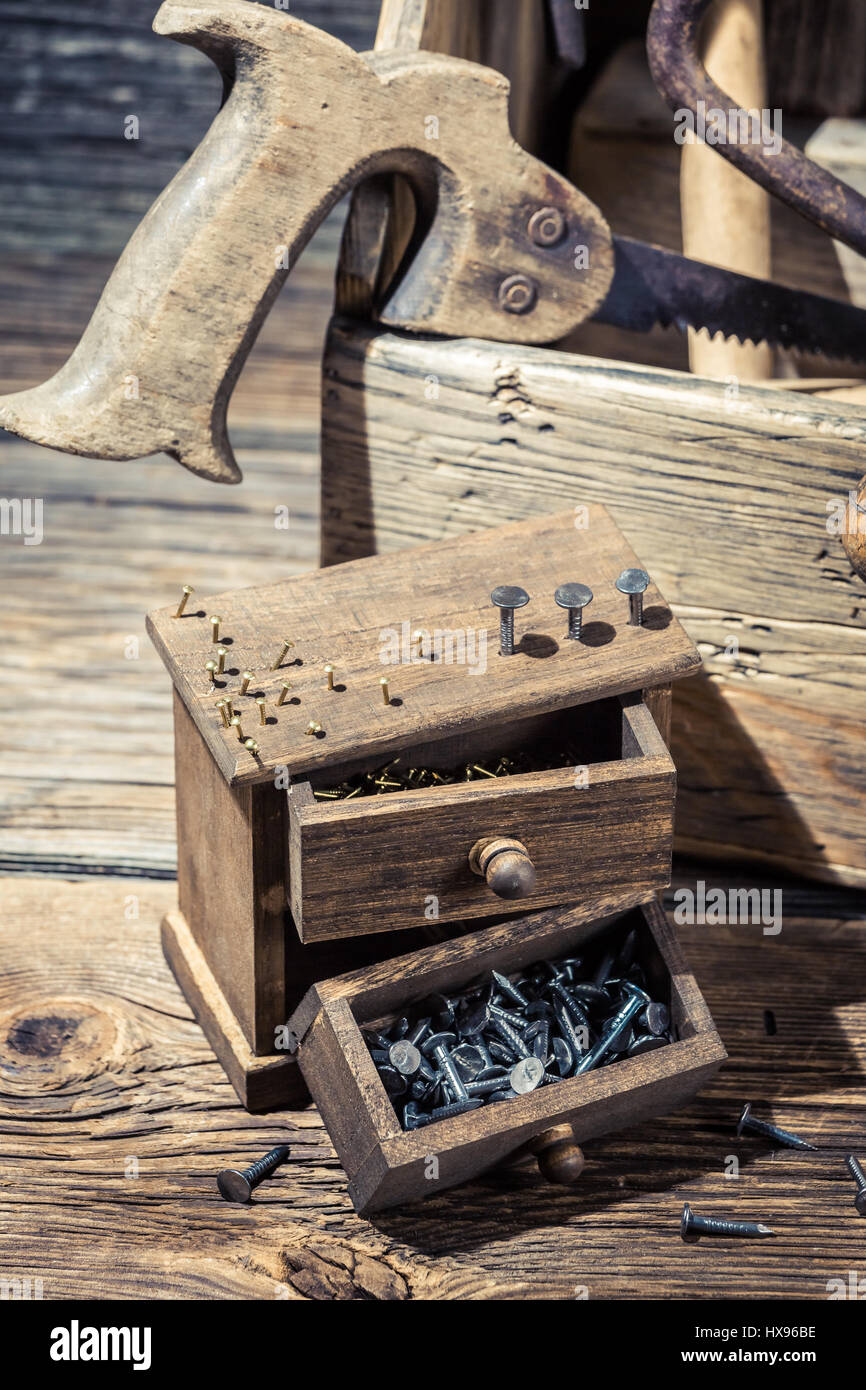 Nails and tool box in carpenter workbench Stock Photo - Alamy