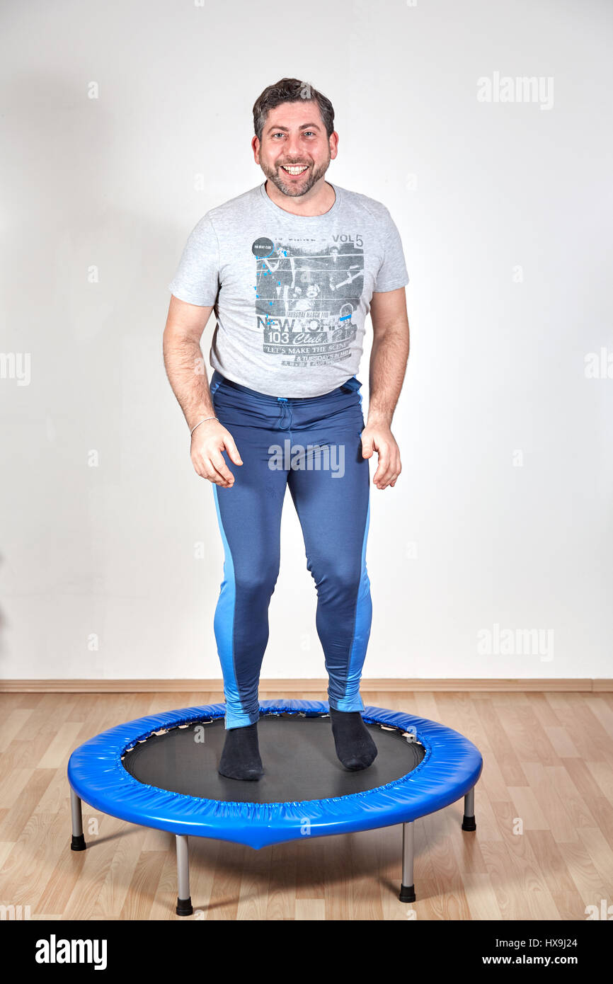 Man doing fitness for healthy lifestyle jumping on trampoline Stock ...