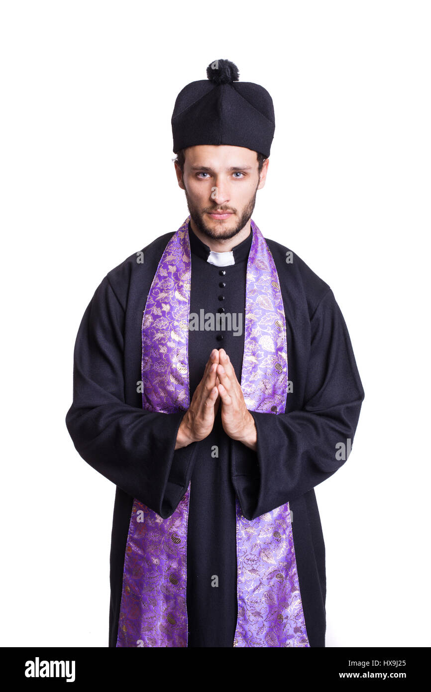 Portrait of young priest. Studio portrait isolated on white background ...