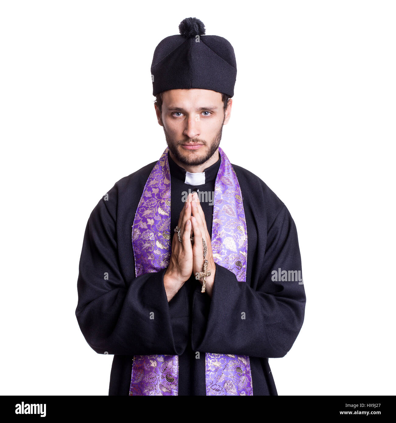 Portrait of young priest. Studio portrait isolated on white background ...