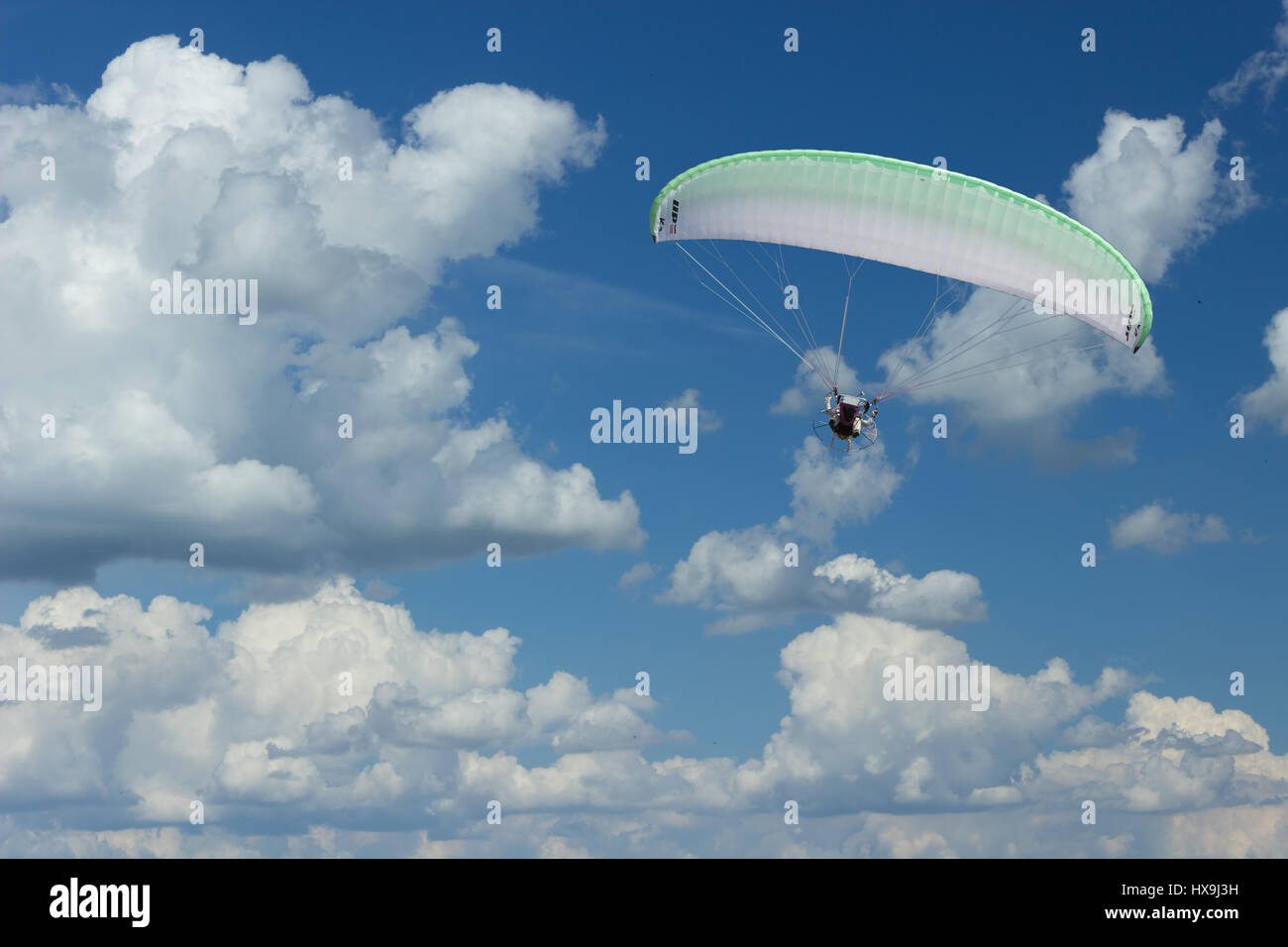 A motor parachute or paramotor flying in the sky Stock Photo - Alamy