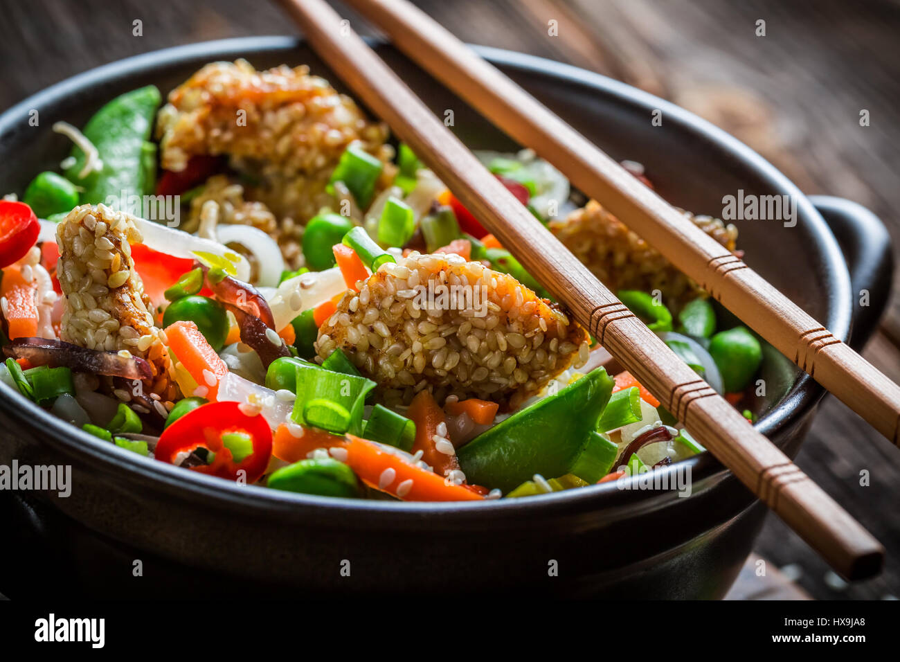 Chicken with sesame with vegetables and noodles Stock Photo - Alamy