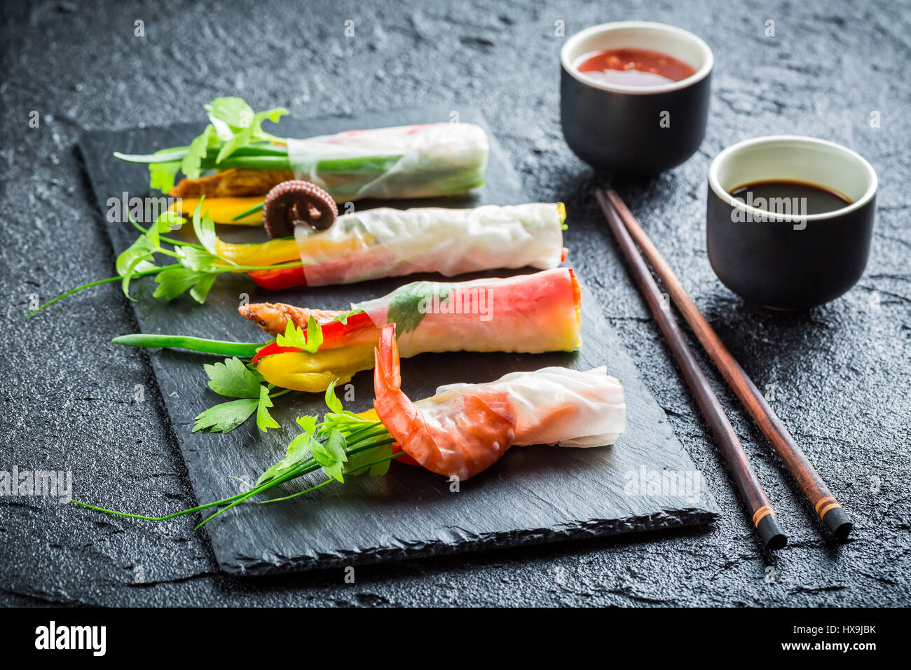 Spring rolls with vegetables with sauce on black rock Stock Photo - Alamy