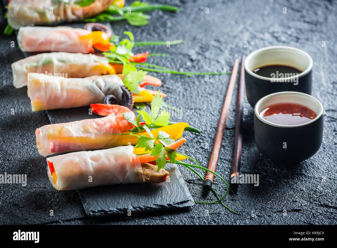 Spring rolls served with soy sauce on a stone plate Stock Photo - Alamy