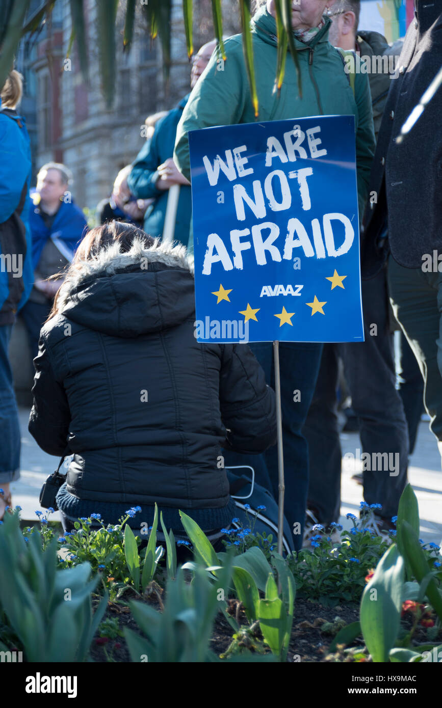A protestor sitting down with her "We are not afraid" sign during the ...