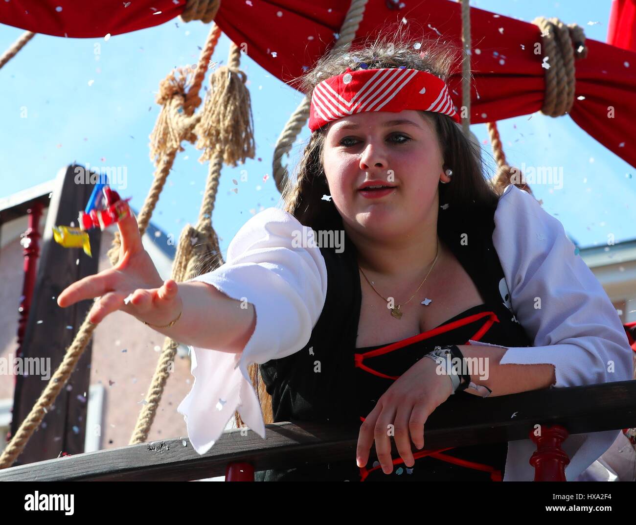 Petange. 26th Mar, 2017. A reveller throws candies during the cavalcade ...