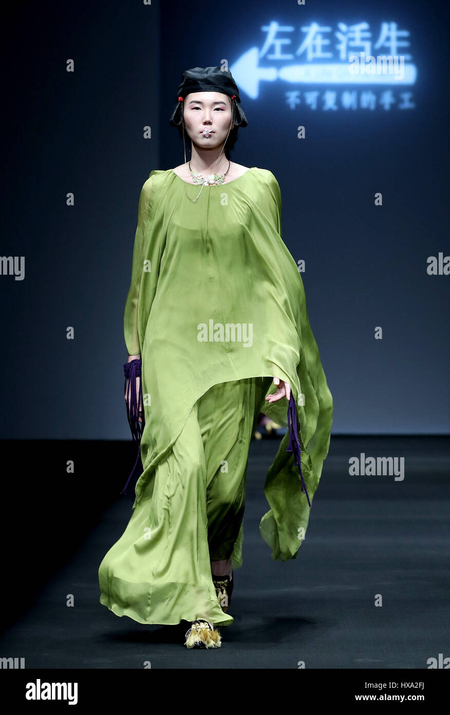 Beijing, China. 26th Mar, 2017. A model presents a creation by Lin Qi ...
