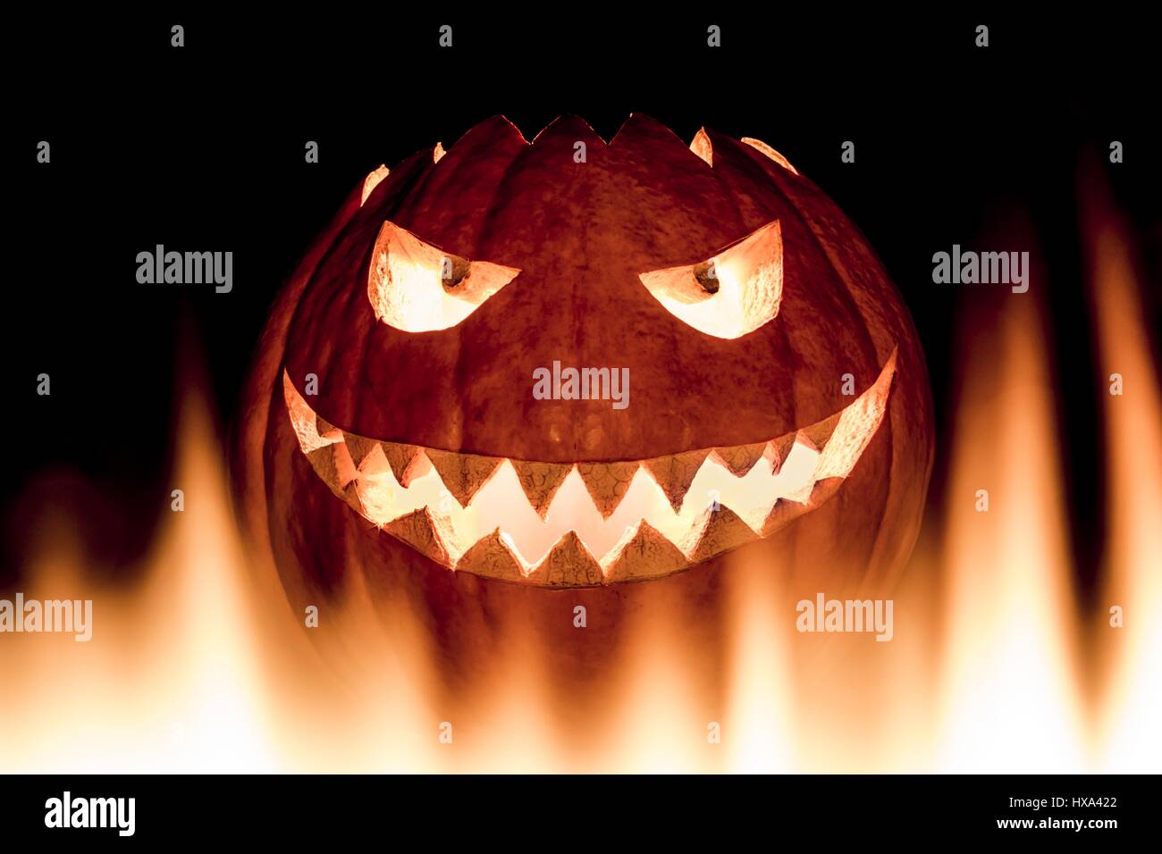 Scary carved halloween pumpkin in hot burning hell fire flames. The big ...