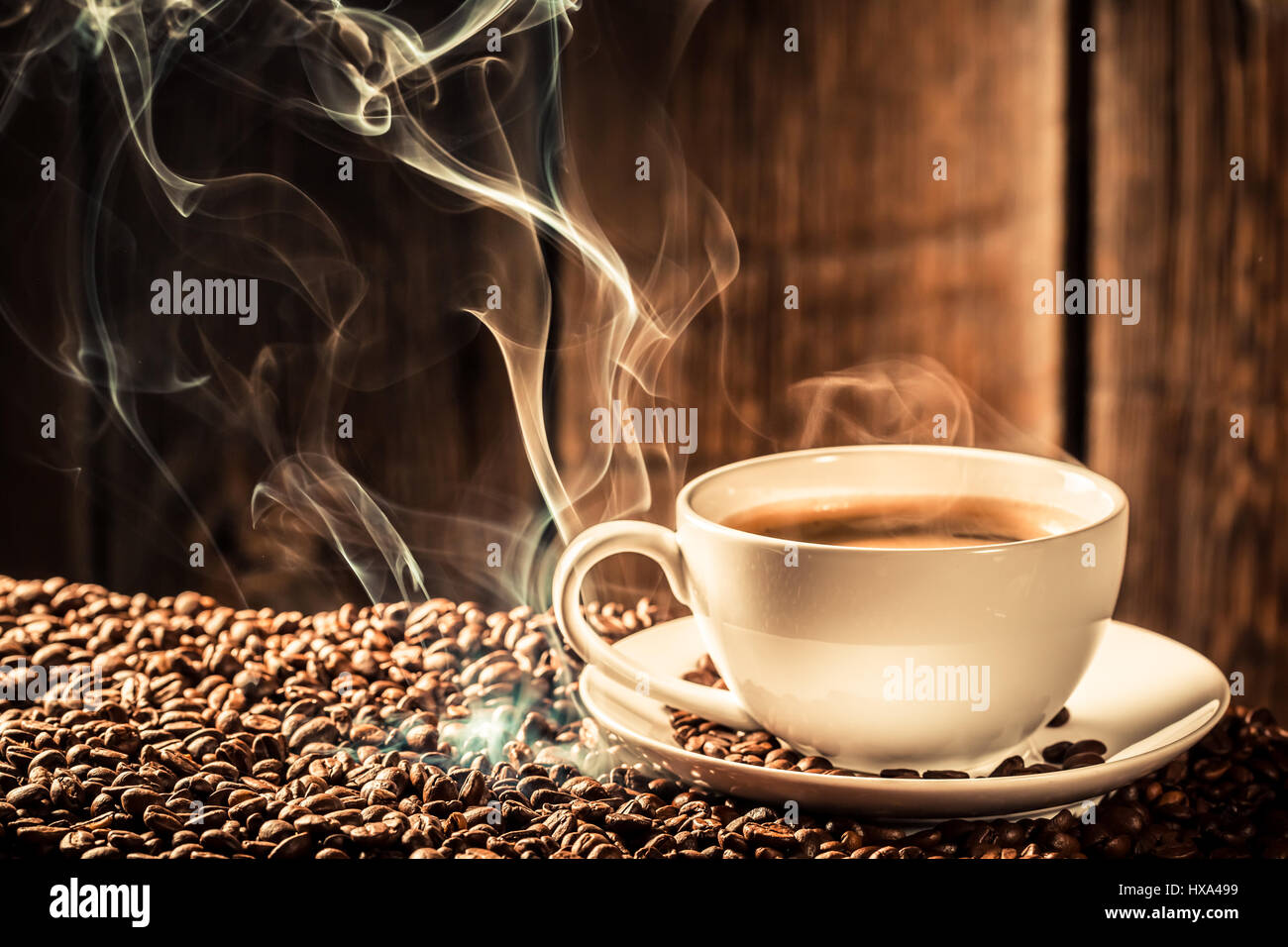 Taste cup of coffee with roasted grains Stock Photo - Alamy