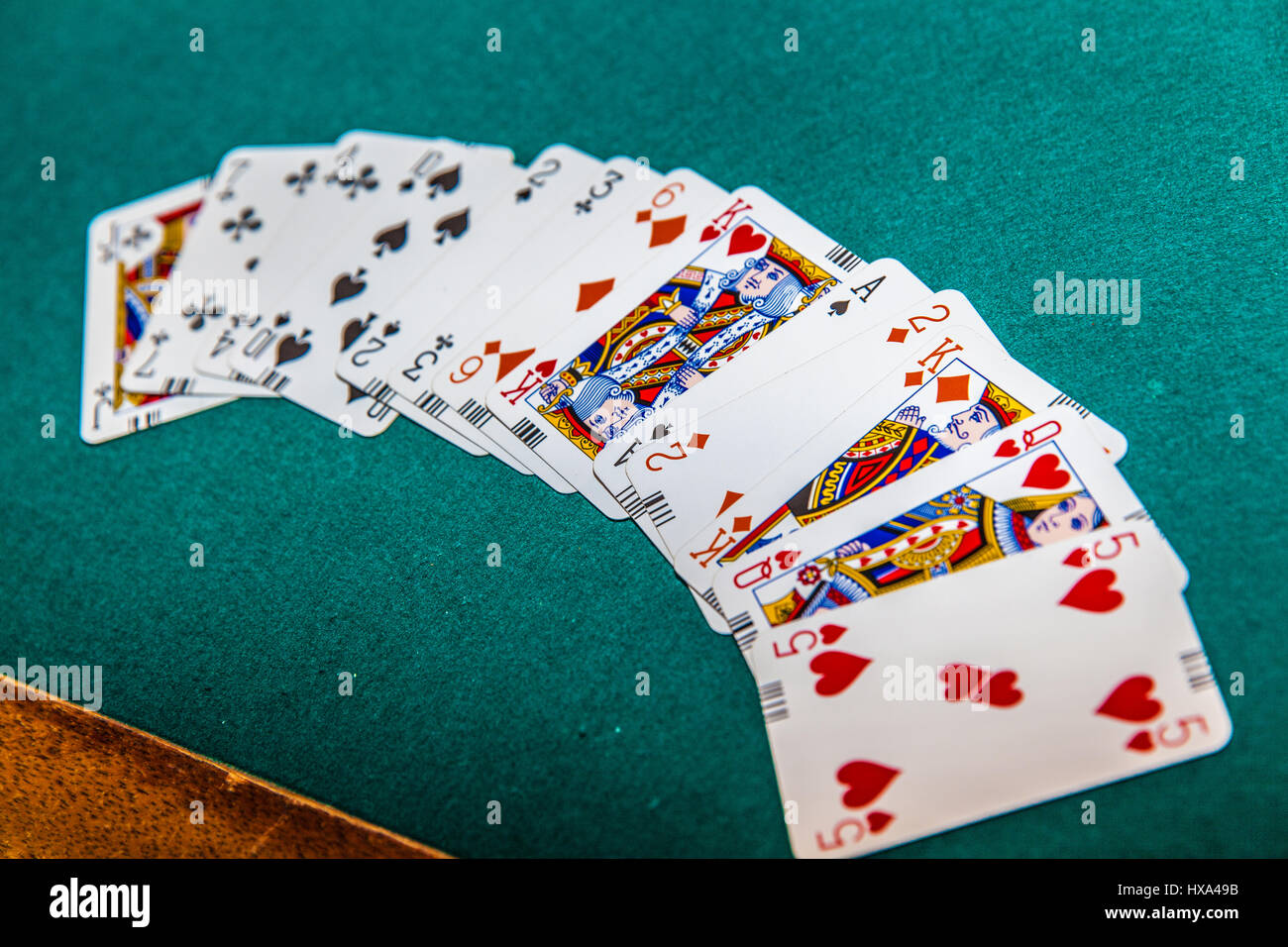 bridge game cards spread on a green deck Stock Photo - Alamy
