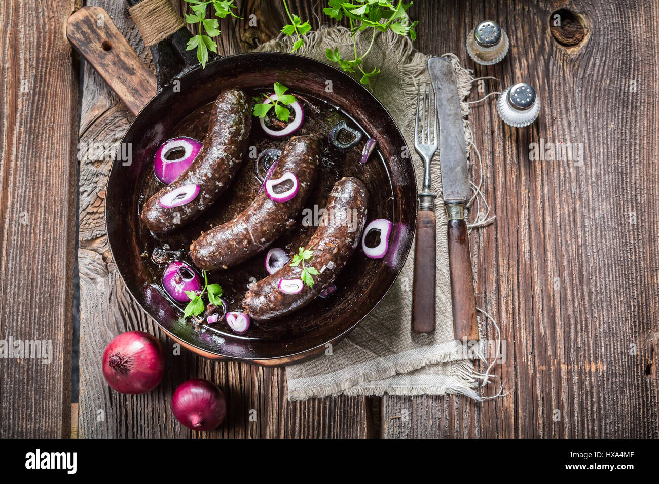 Homemade black pudding on pan on old wooden table Stock Photo - Alamy