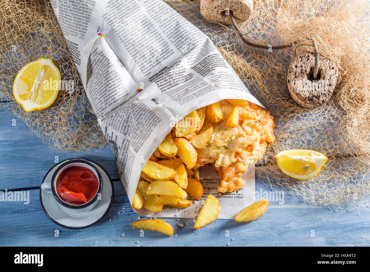 Homemade fish and chips served in paper Stock Photo - Alamy