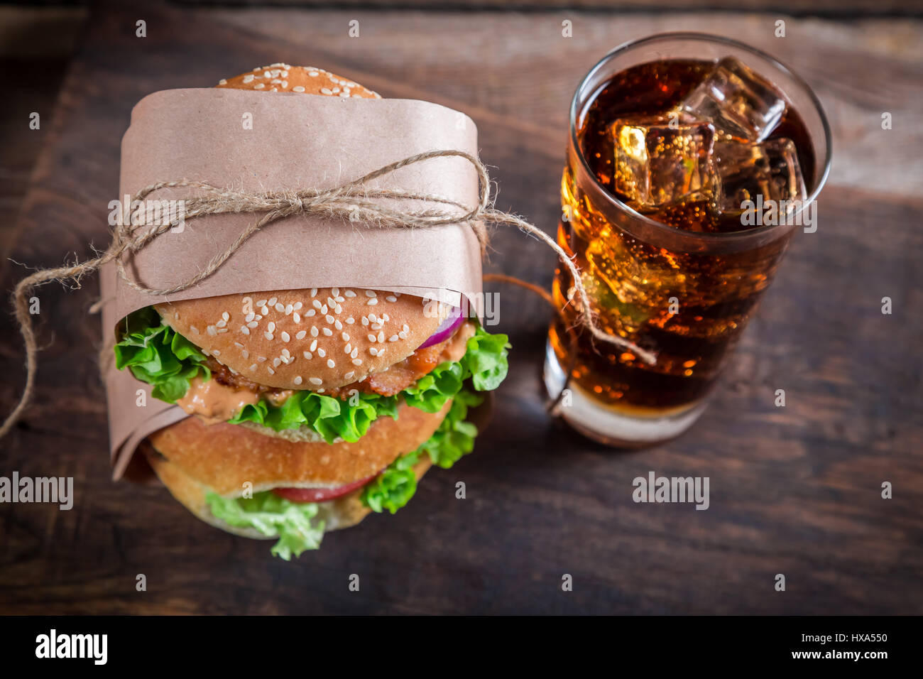 Takeaway homemade hamburger with cold drink on old wooden table Stock ...
