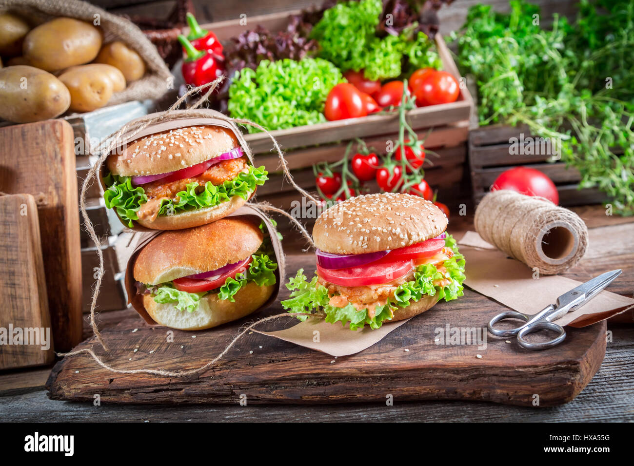 Homemade takeaway hamburger on old wooden table Stock Photo - Alamy