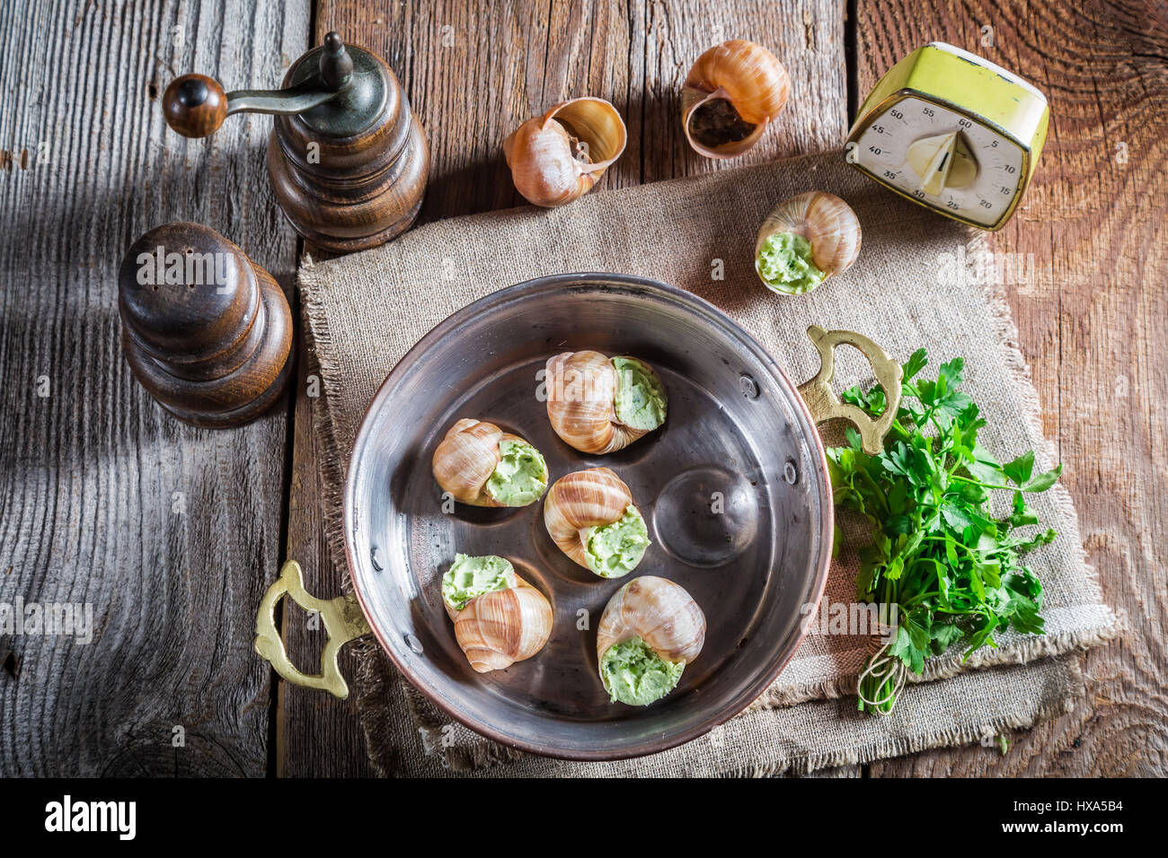 Homemade snails with garlic butter on old wooden table Stock Photo - Alamy