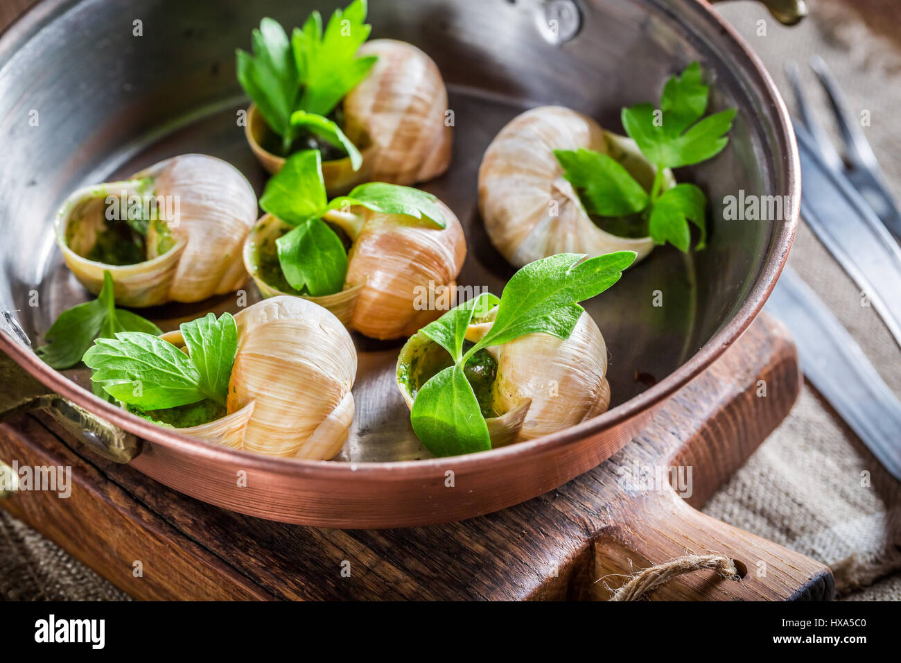 Roasted snails with garlic butter and parsley Stock Photo - Alamy