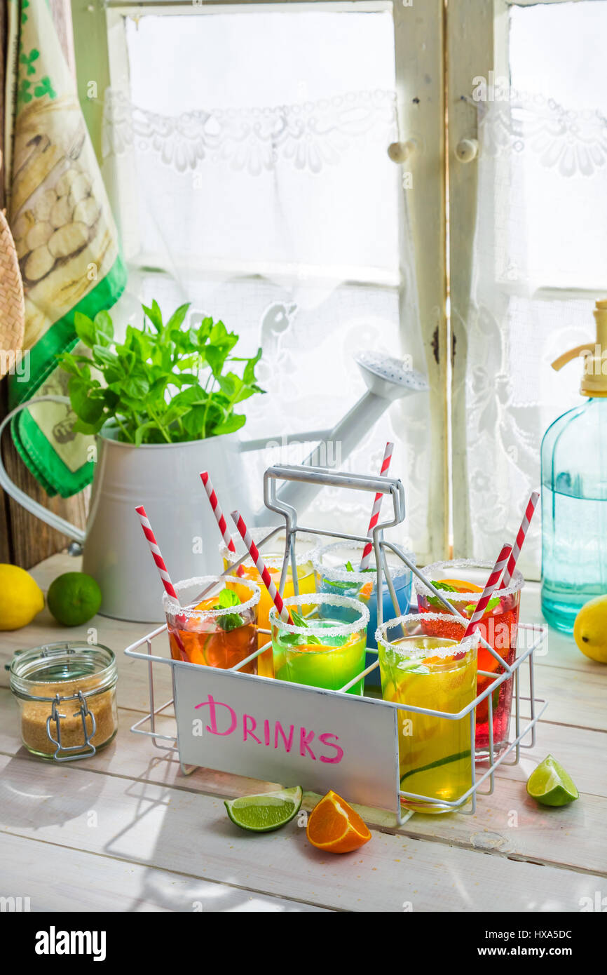Cold drink with straw and fruits on old white table Stock Photo - Alamy