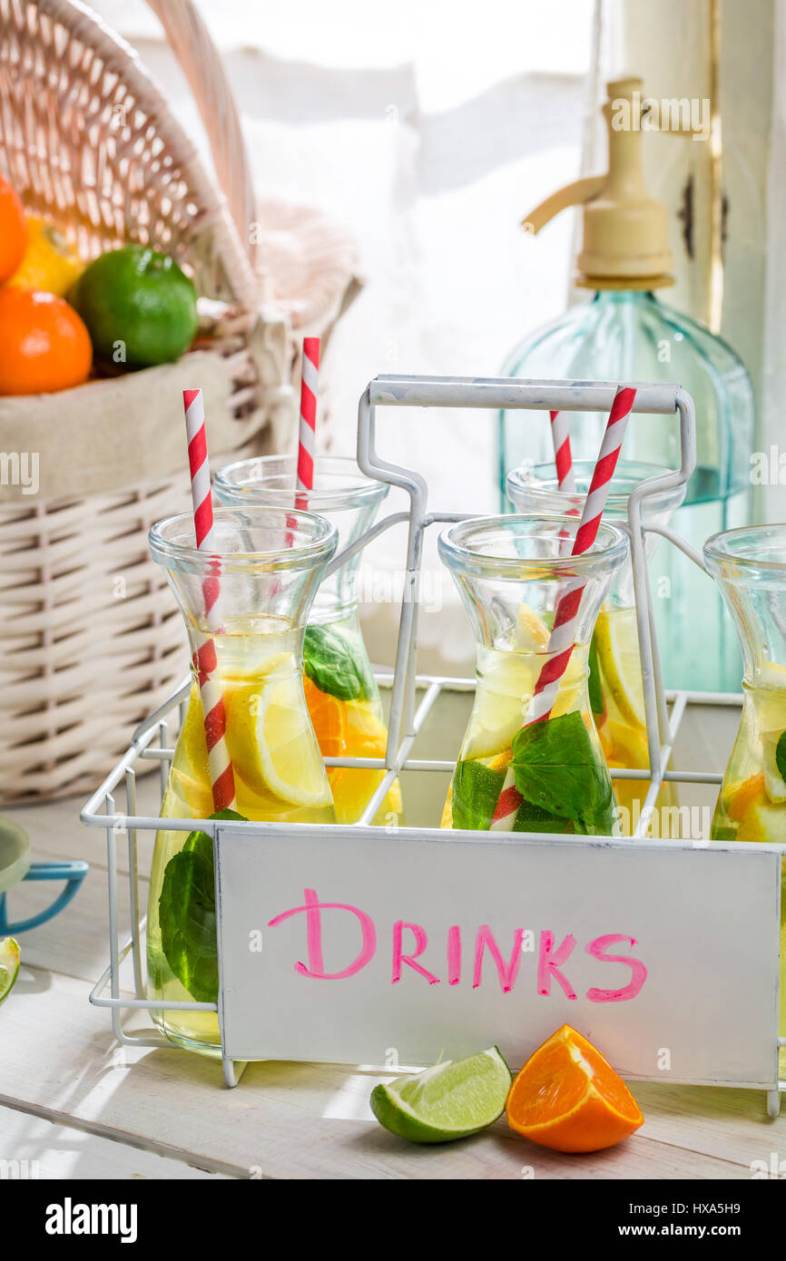 Tasty drink with lime and lemon on old white table Stock Photo - Alamy