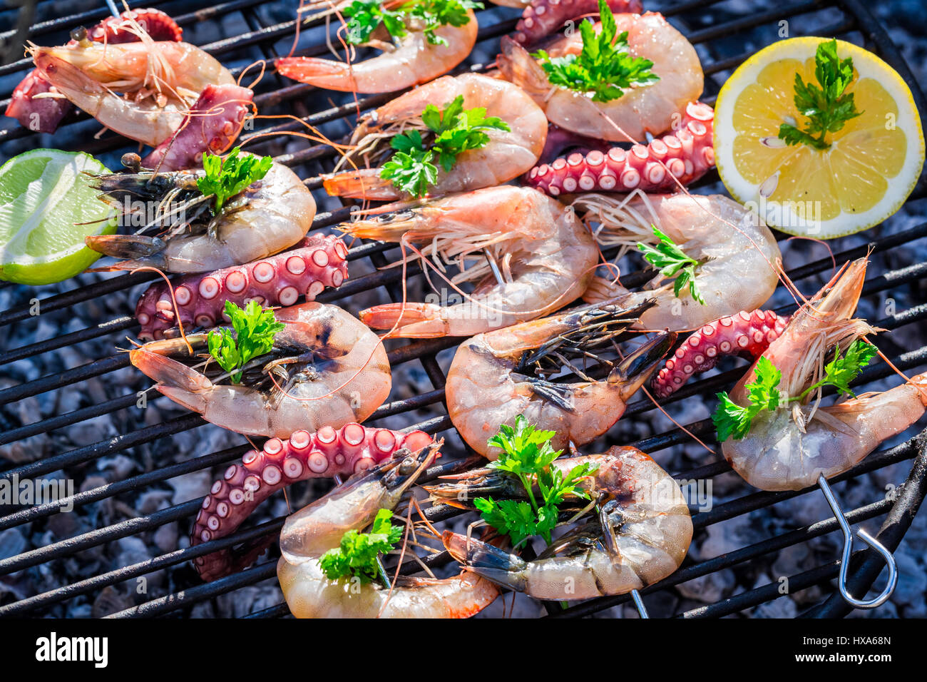 Grilling fresh seafood with lemon and parsley Stock Photo - Alamy