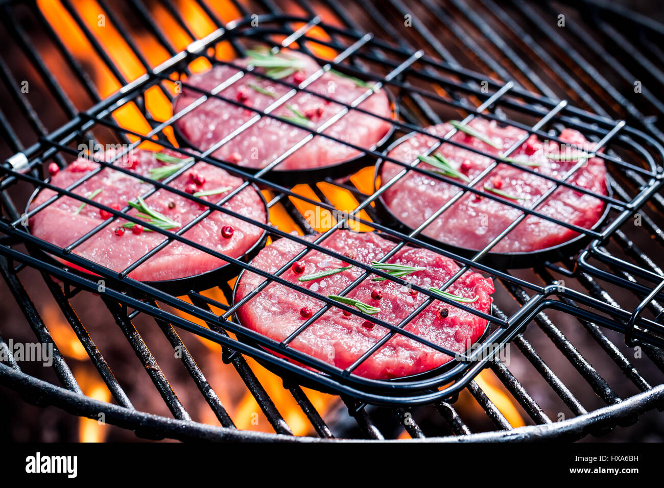 Roasting red steak with rosemary and pepper Stock Photo - Alamy