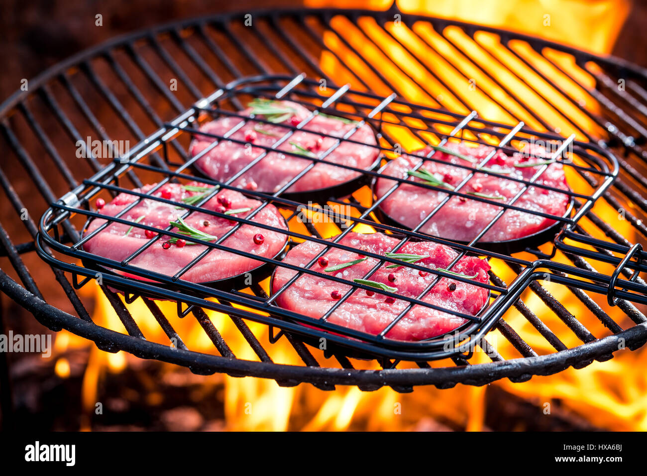 Grilling red beef with rosemary and pepper Stock Photo - Alamy
