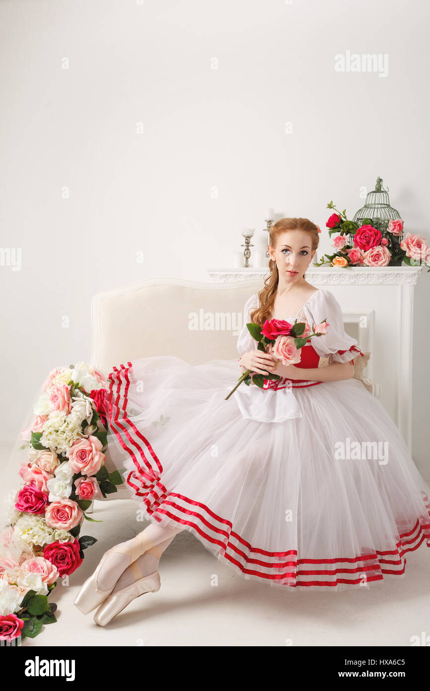 Cute Ballerina In Stage Costume Holding A Bouquet Of Spring Flowers
