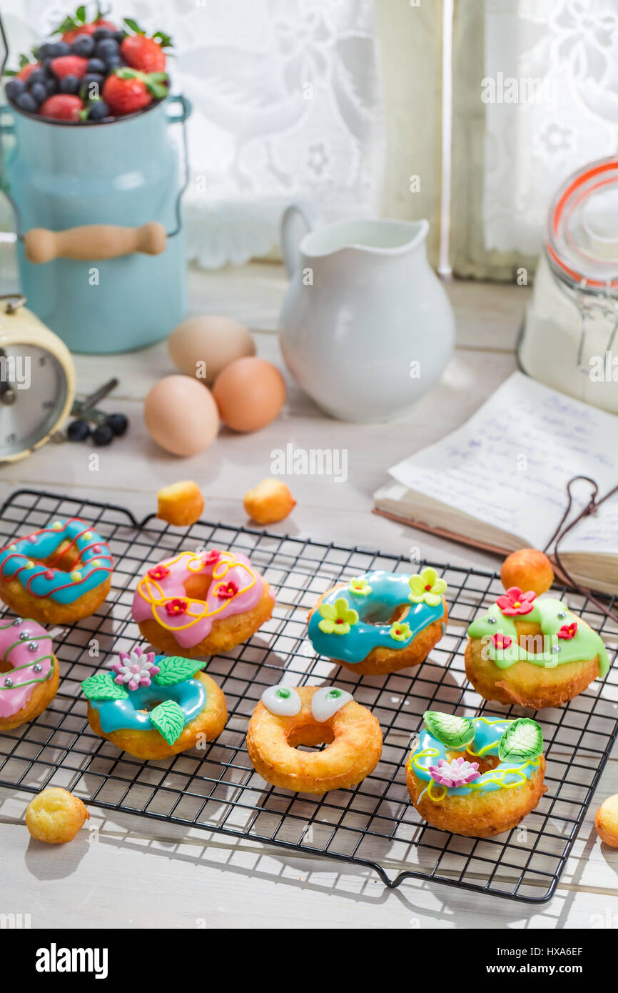 Glazed delicious donuts on old white table Stock Photo - Alamy