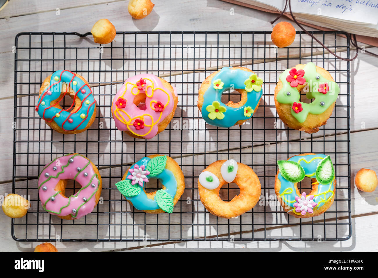 Decorating homemade donuts in the sunny kitchen Stock Photo - Alamy