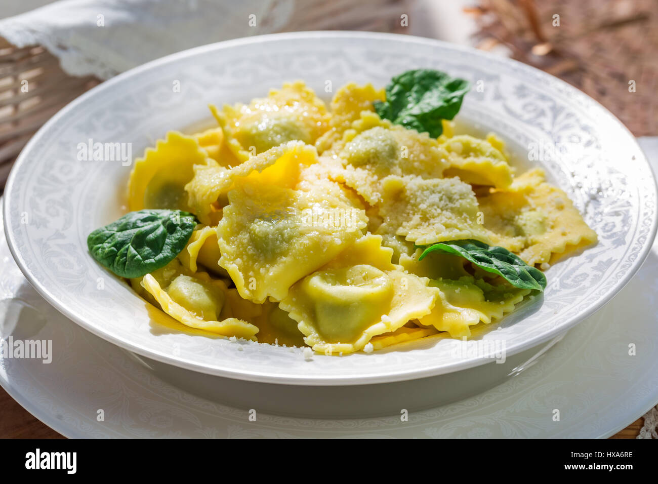 Tasty ravioli with parmesan on old white table Stock Photo - Alamy