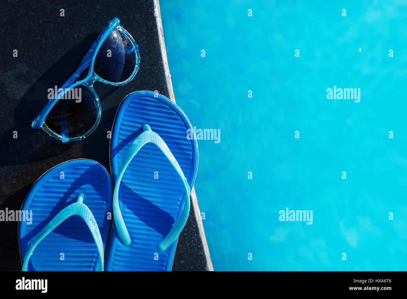Blue slippers and sunglasses on border of a swimming pool - holiday ...